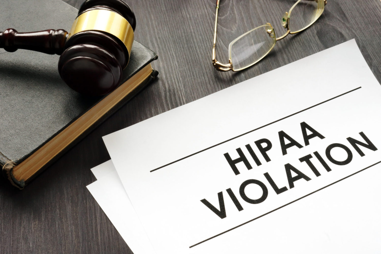 Documents about HIPAA violation and gavel in a court. | PAAS National