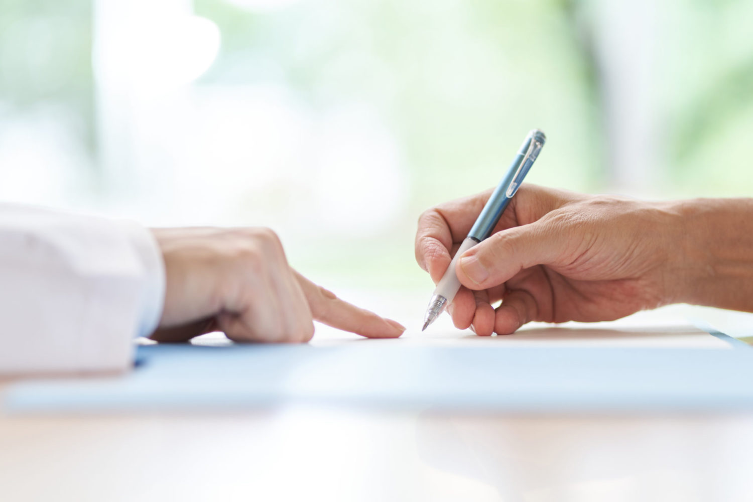 Elderly people signing with a doctor explaining the contract | PAAS ...
