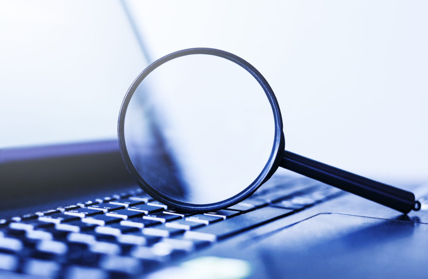Laptop computer with magnifying glass, concept of search | PAAS National